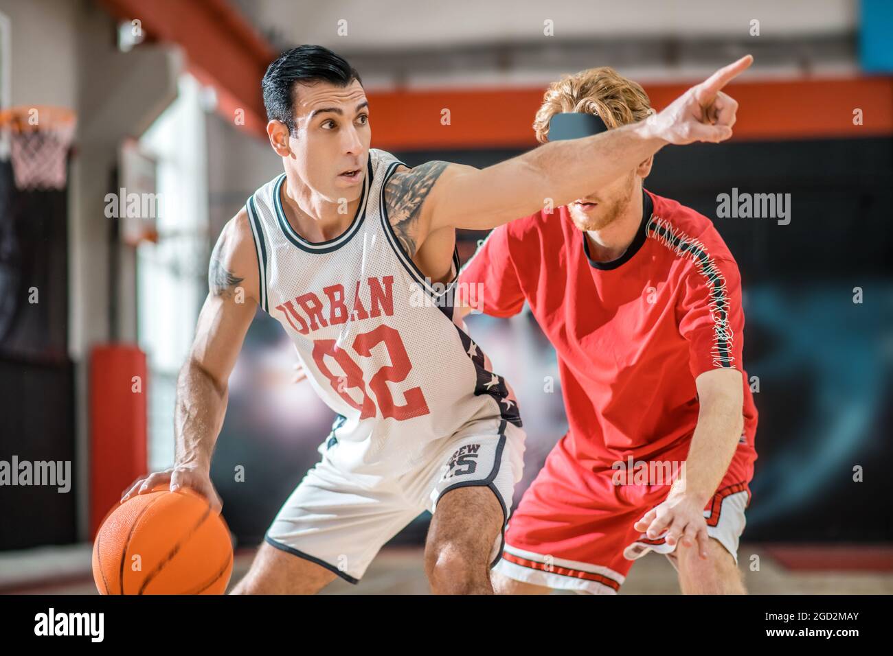 Two young men playing basketball and feeling excited Stock Photo - Alamy