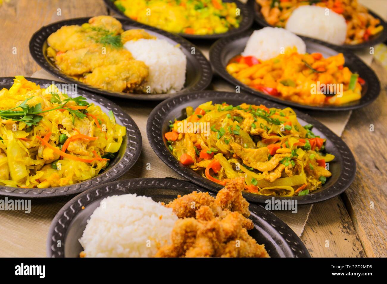 Plates with delicious oriental food on an old wooden table Stock Photo ...
