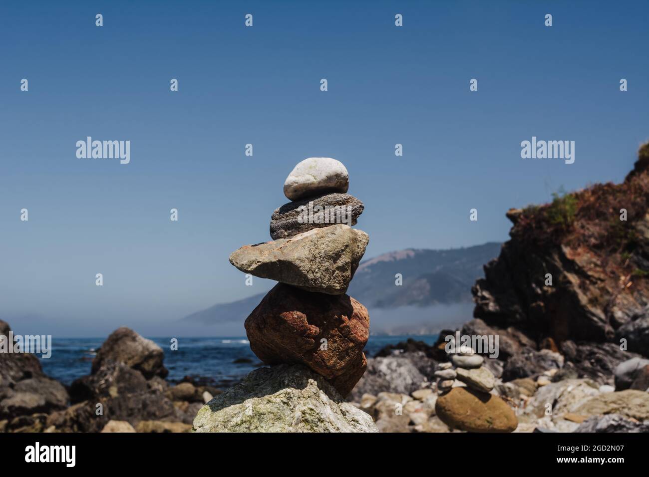 Rocks of different sizes, shapes and colors on top of each other on the ...