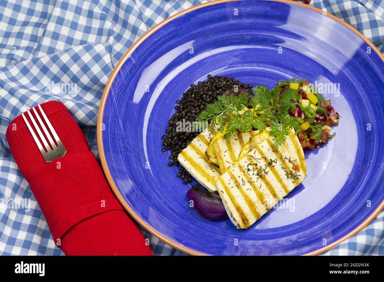 Top view of grilled tofu with toppings on a blue plate Stock Photo - Alamy