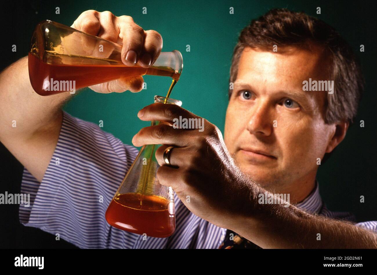 A chemist examines a sample of corn fiber oil for color and quality ...