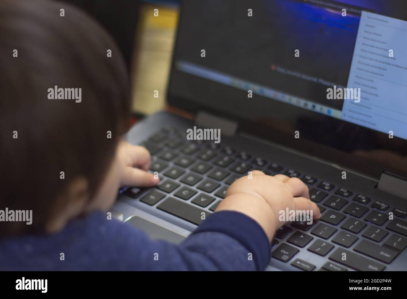 Cute small child playing on a computer Stock Photo - Alamy