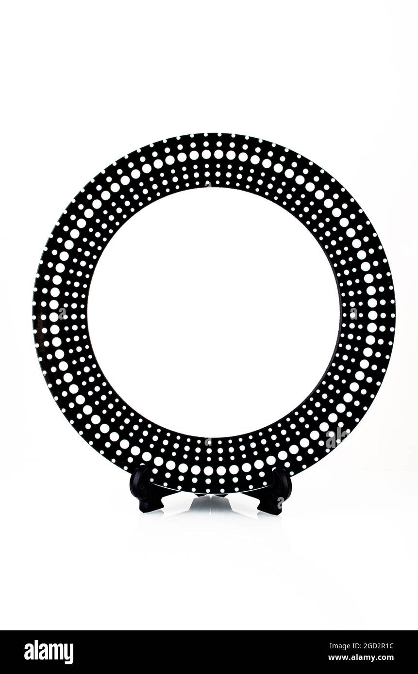 White plate with a black rim, on a white background, for advertising ...