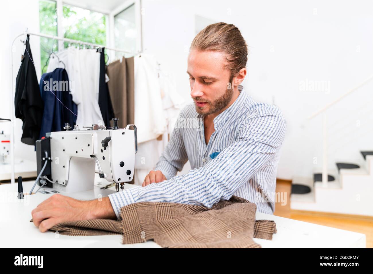 Clothing stylist creating a new design for a dress - Fashion designer ...