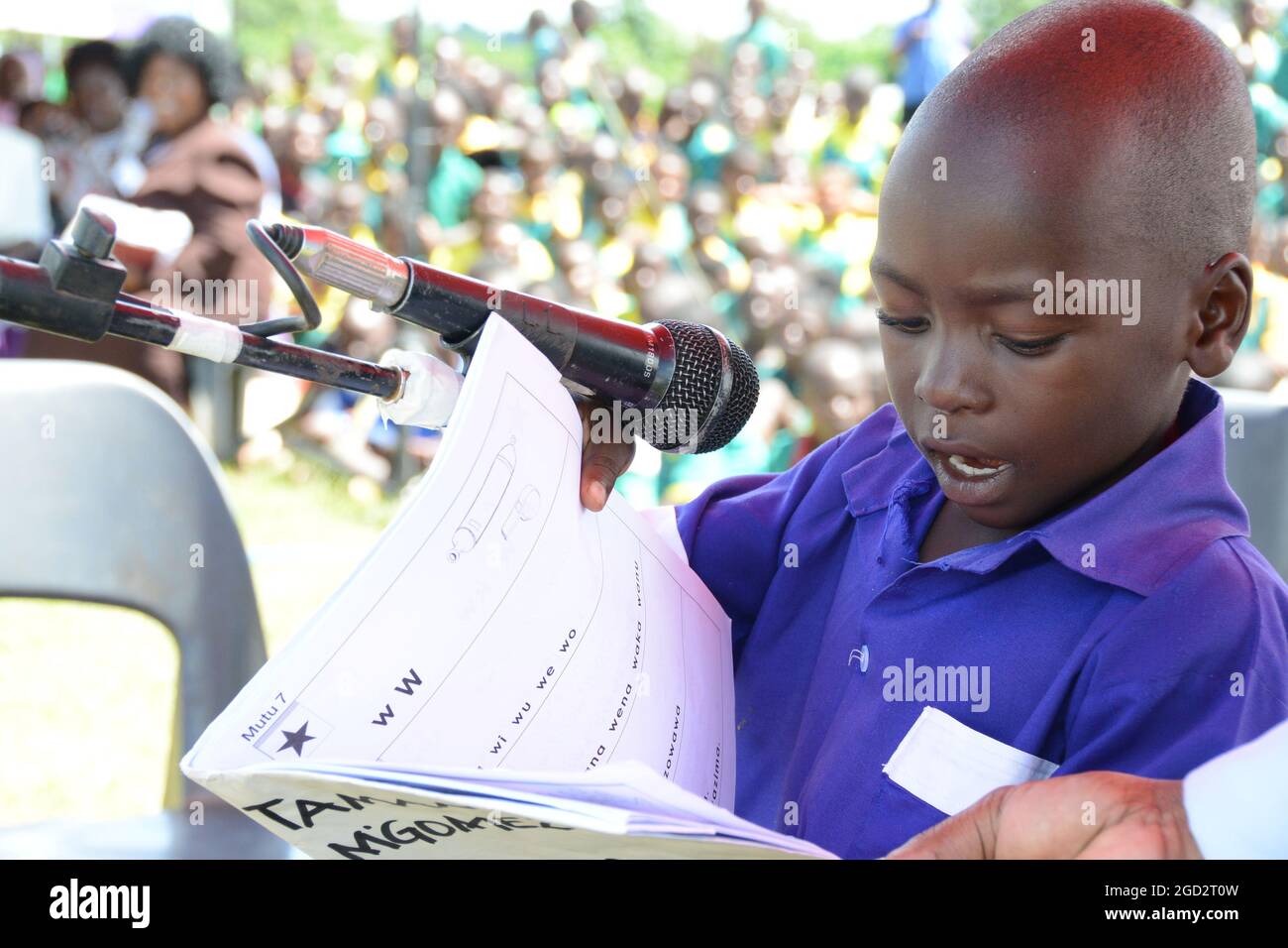 In Malawi, a young primary school student demonstrates his reading ...