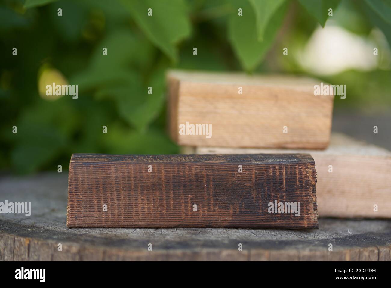 Wooden podium on a green background. Flat square stands or podium for a ...