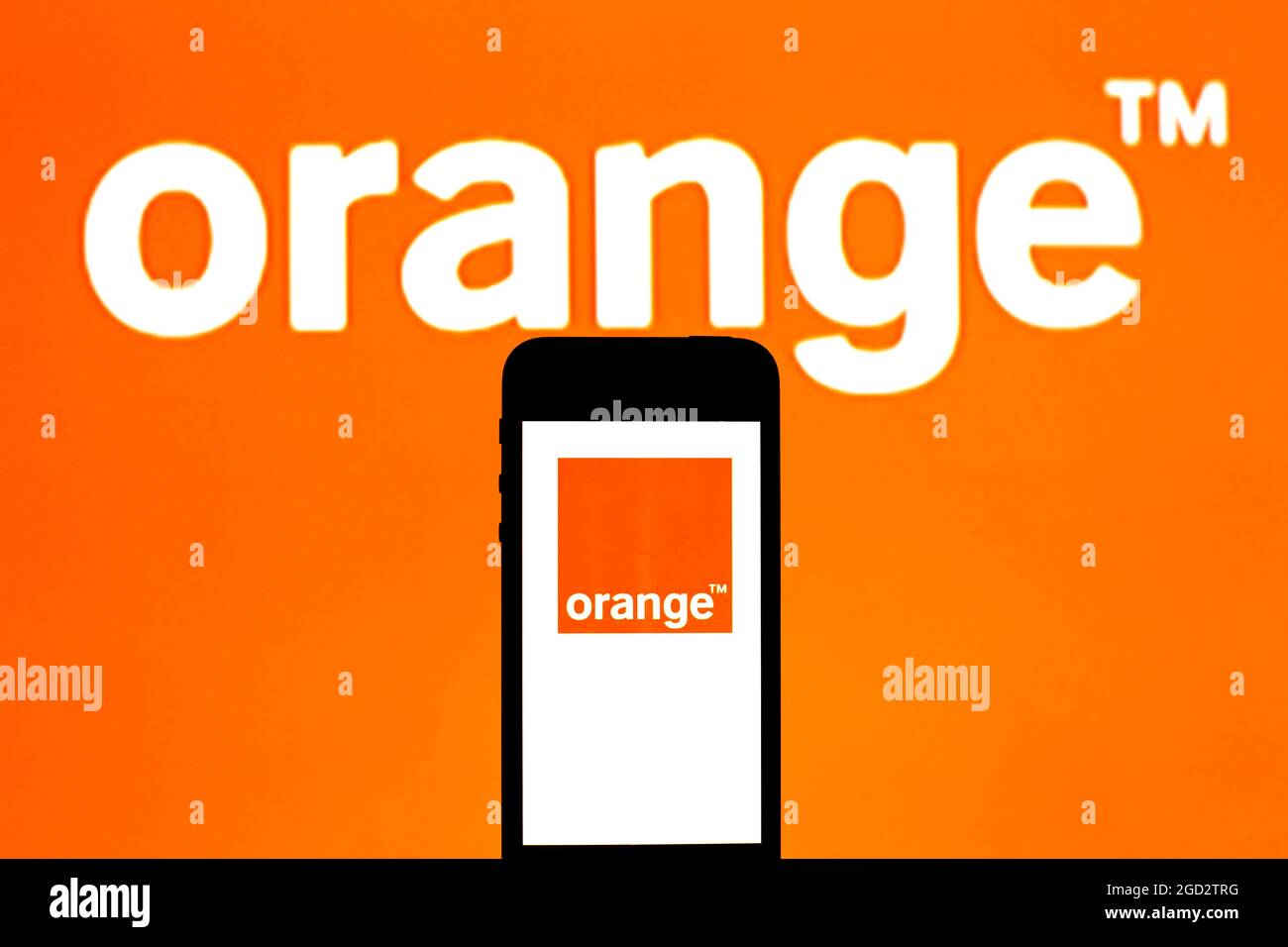 In this photo illustration, an Orange S.A. logo seen displayed on a ...