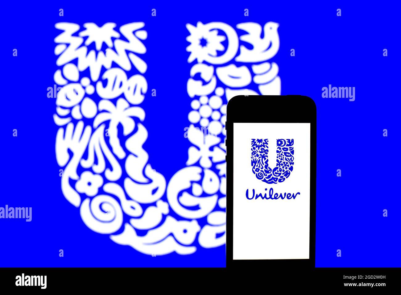 In this photo illustration, a Unilever logo seen displayed on a ...
