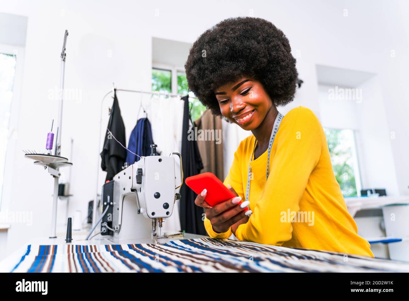 Fashion designer working in a clothing start-up workshop - Clothing ...