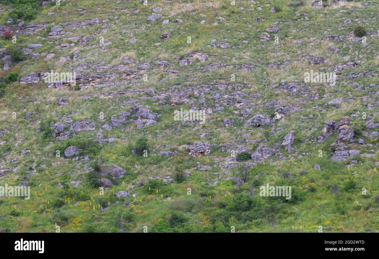 Landscape of a hill made of rocks with grass among Stock Photo - Alamy