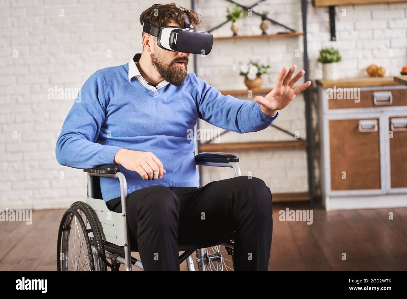 Man sitting in a wheelchair and wearing a VR headset Stock Photo - Alamy