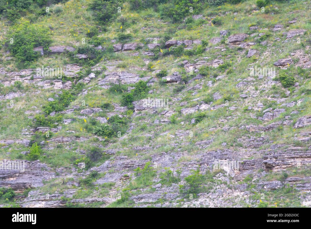 Landscape of a hill made of rocks with grass among Stock Photo - Alamy