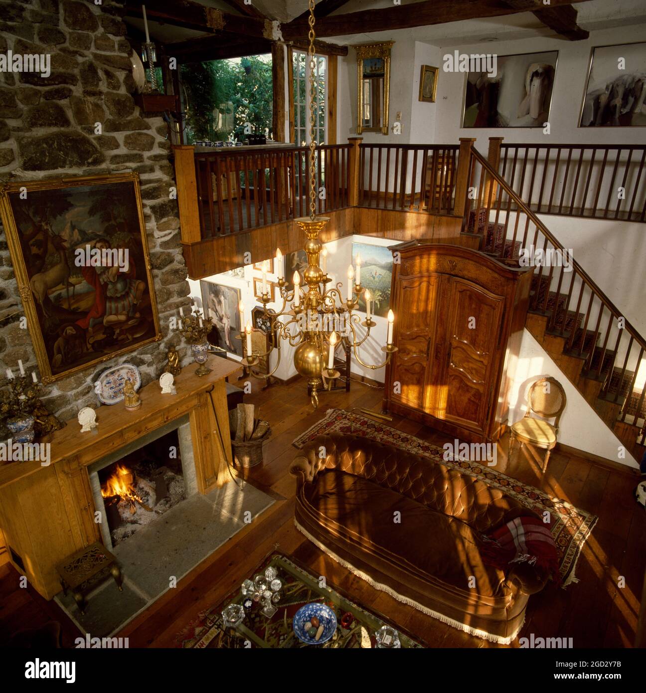 View of living space with open fire from gallery above Stock Photo - Alamy