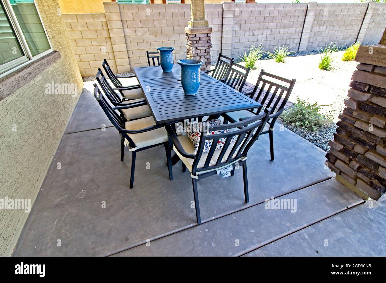 Oblong Patio Table With Eiqht Chairs And Two Vases Stock Photo - Alamy