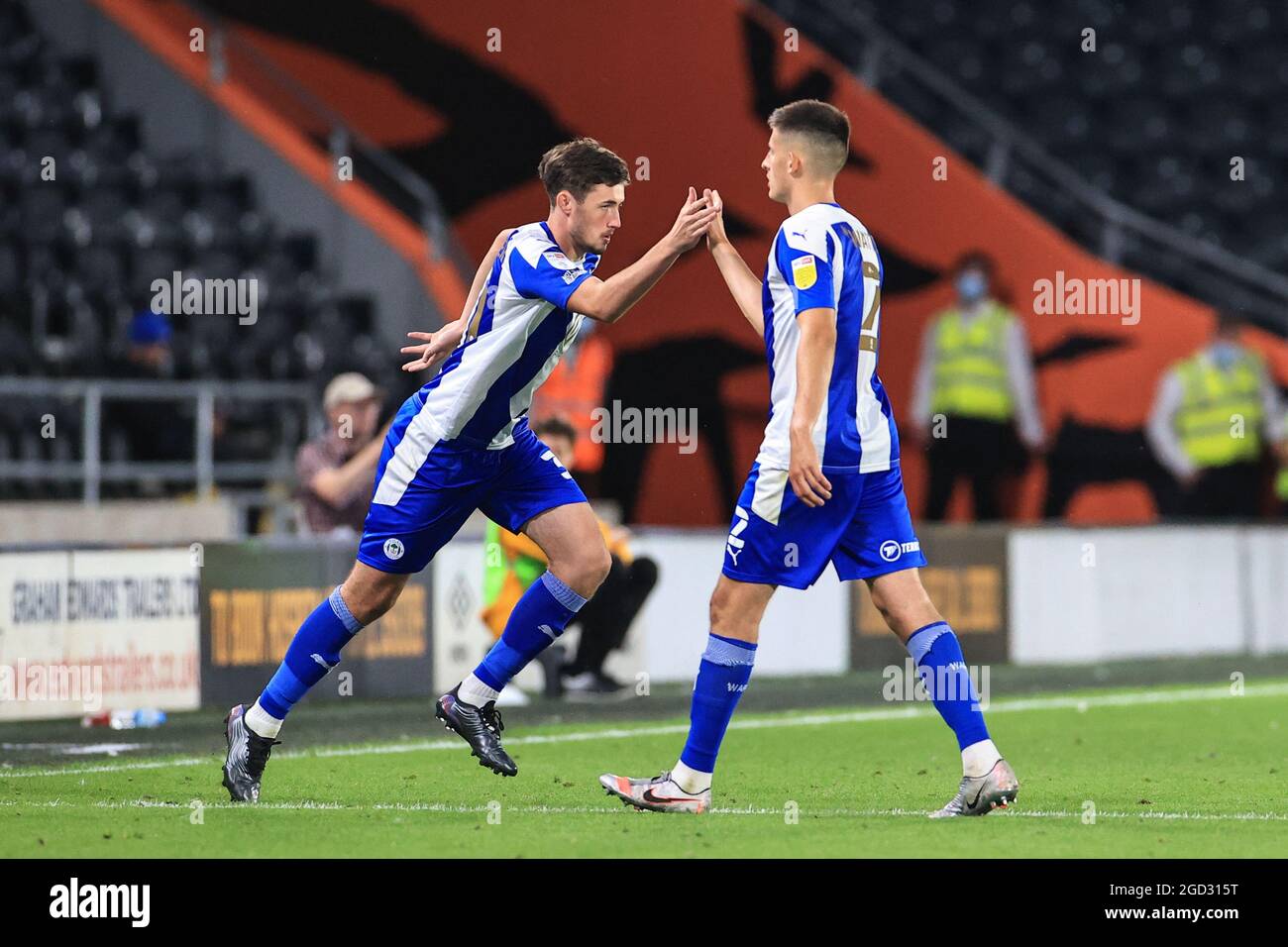 Kell Watts #2 of Wigan Athletic makes way for Liverpool legend Jamie ...