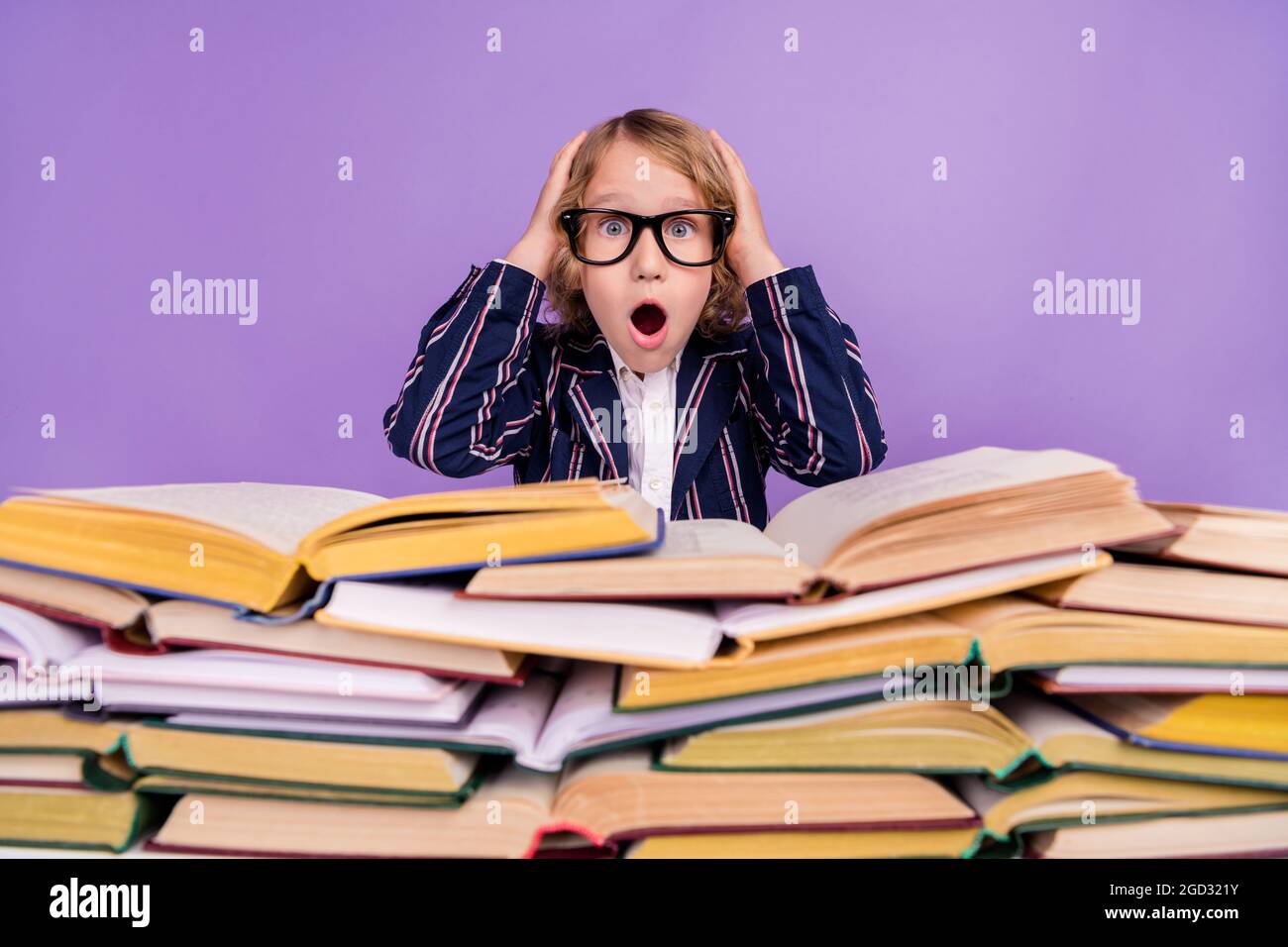 Portrait of attractive funny amazed boy reading pile book omg reaction ...