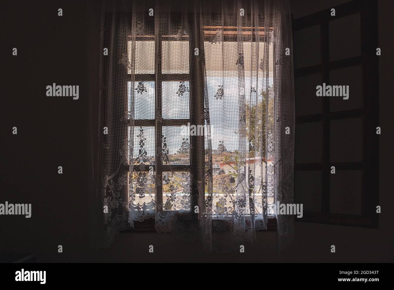 View outside from Greek traditional house opened window with curtains ...