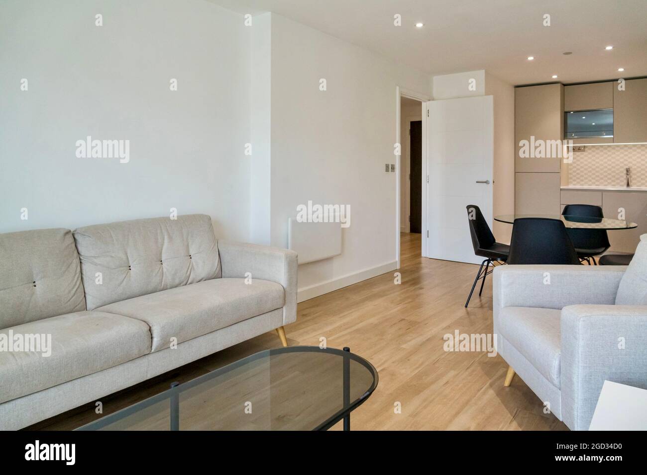 A brand new, empty, open plan kitchen and living room in a modern ...