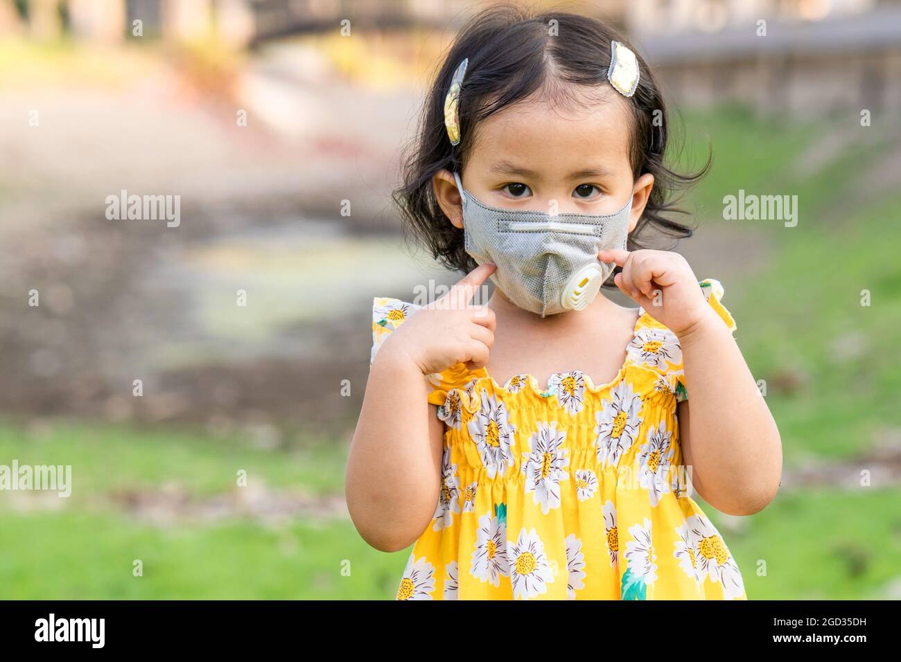 Cute little girl from Thailand in a face mask during the pandemic ...