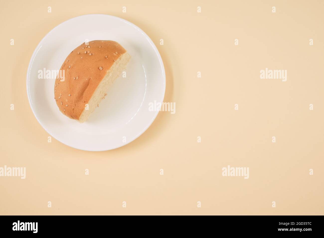 Top view shot of half bread on a coral background Stock Photo - Alamy