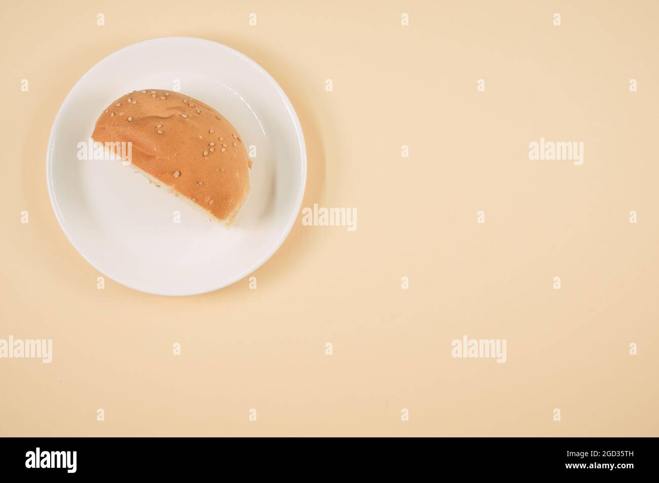 Top view shot of half bread on a coral background Stock Photo - Alamy