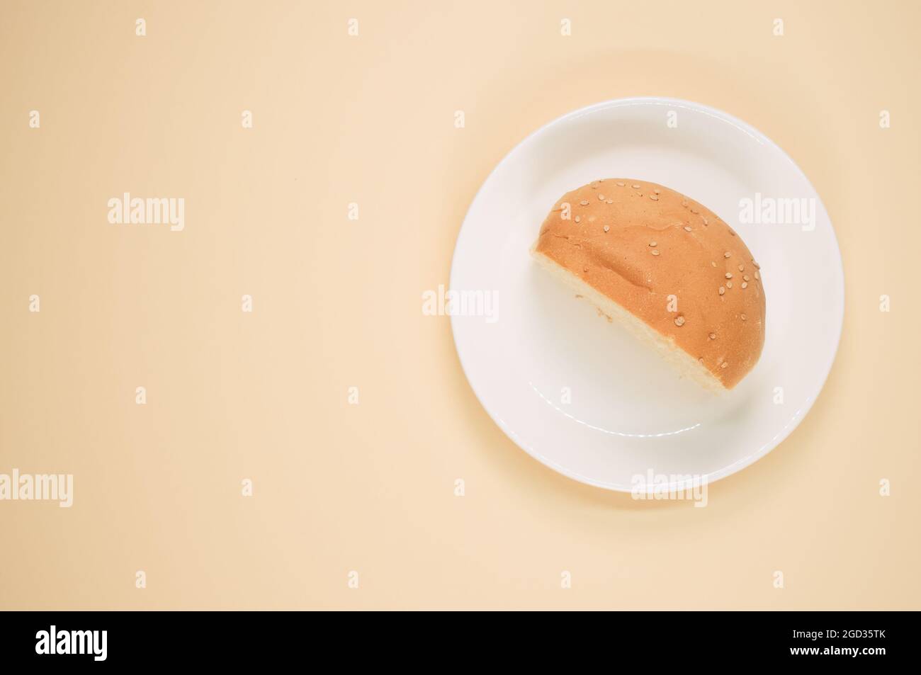 Top view shot of half bread on a coral background Stock Photo - Alamy