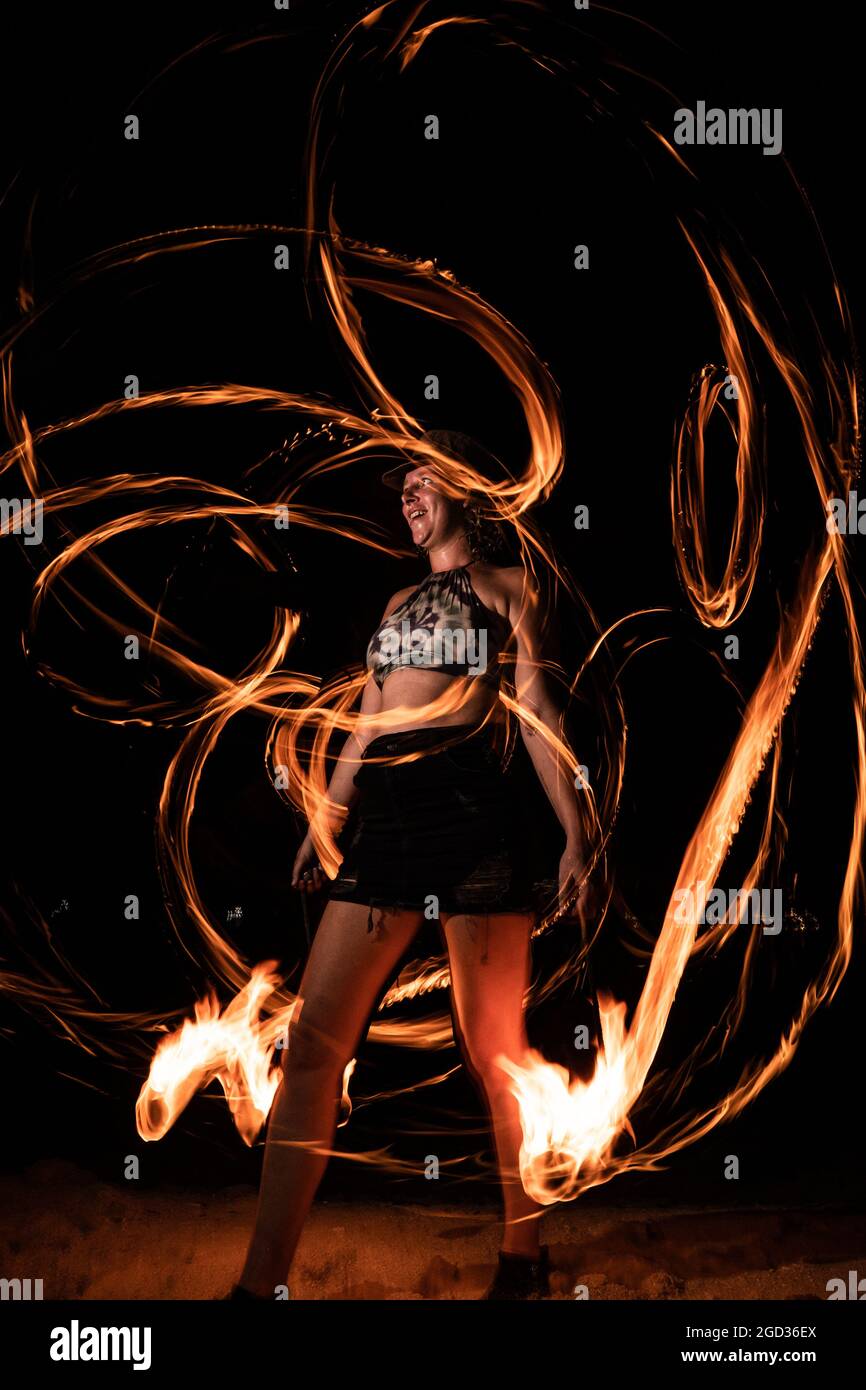 Female performing a fire show at night Stock Photo - Alamy