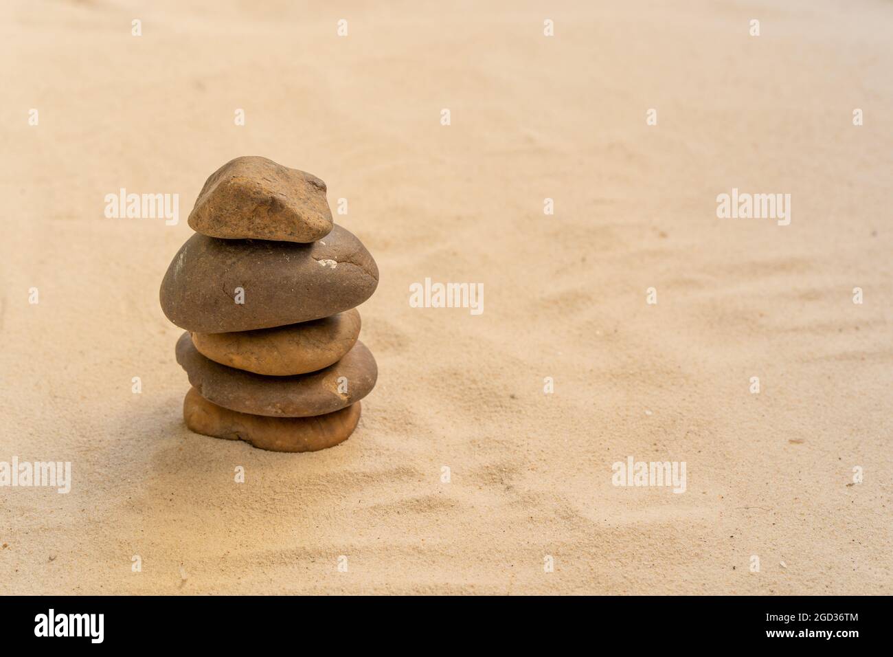 Small pebble tower on the sand on the beach Stock Photo - Alamy