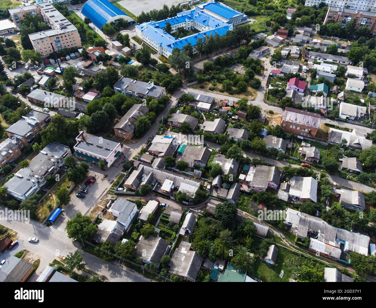 Aerial view of suburb of European city. Green neighbourhood on a sunny ...