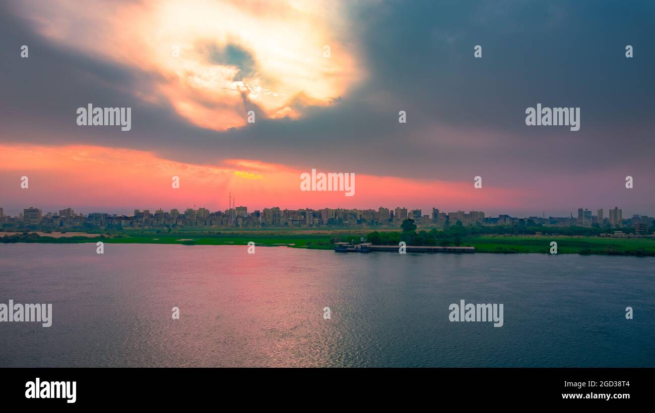 Sunset scene from Sohag city in south Egypt in a cloudy colorful ...