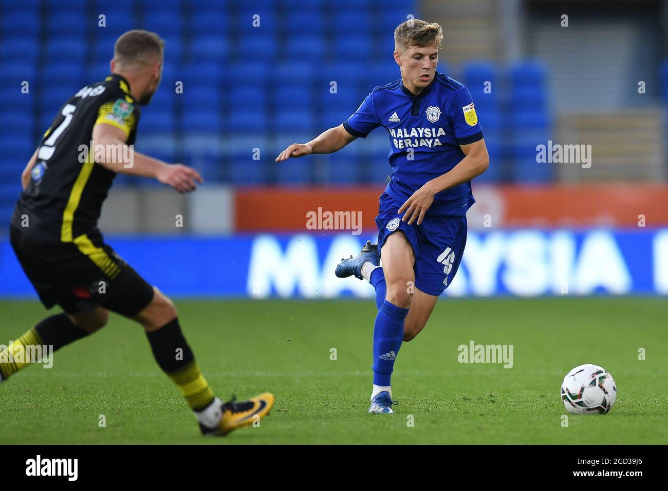 Thomas Davies #40 of Cardiff City under pressure from Jonathan Barden ...