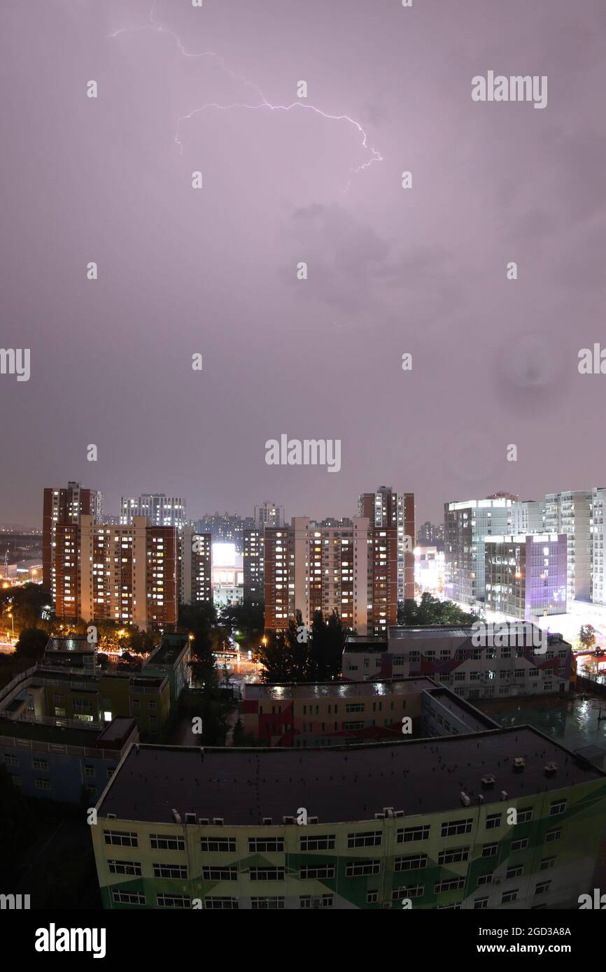 Lightning streaks across the night sky in Chaoyang District. At 18:25 ...
