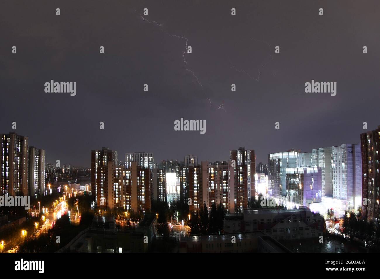 Lightning streaks across the night sky in Chaoyang District. At 18:25 ...
