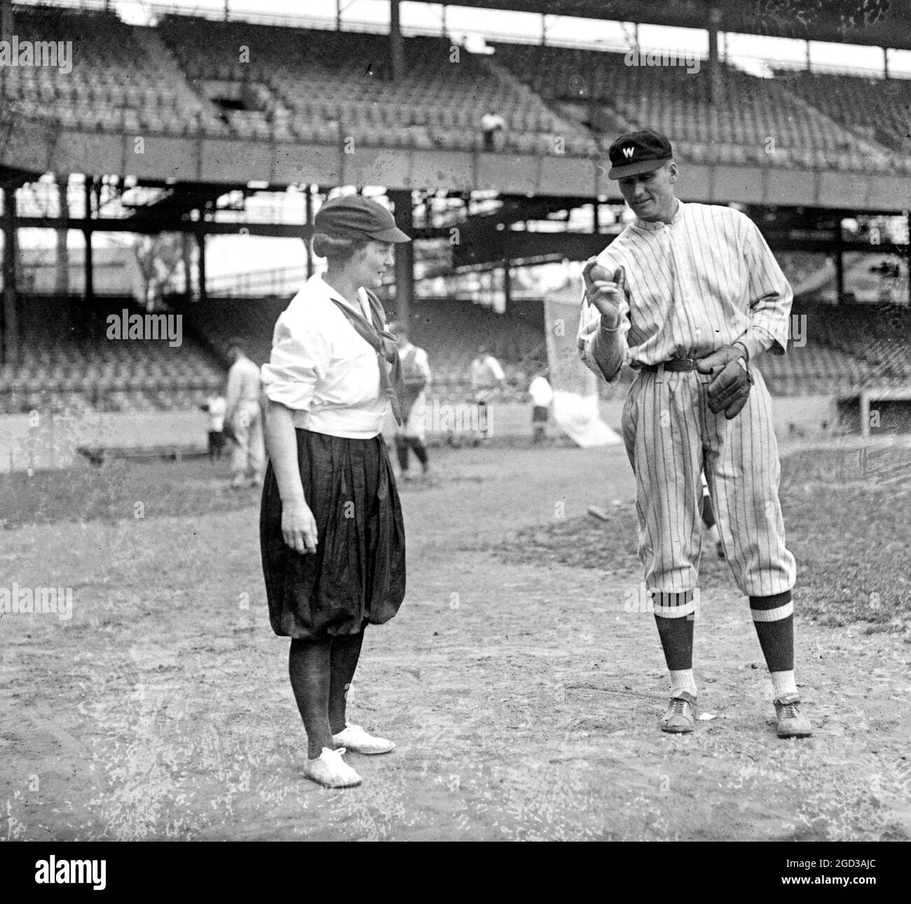 Washington baseball player shows a member of a girls baseball team how ...