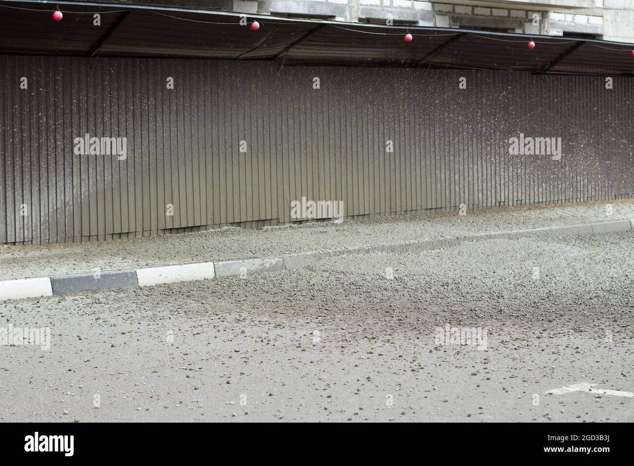 Liquid cement at a construction site. Cement spilled onto the road. The ...