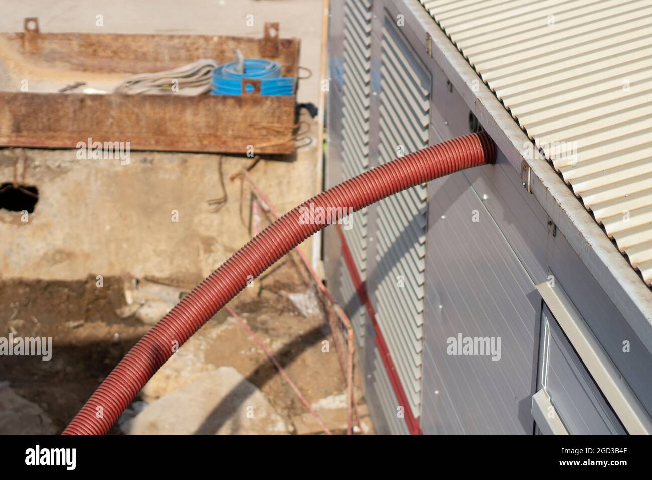 A corrugated cable. The cable enters the structure. True for ...