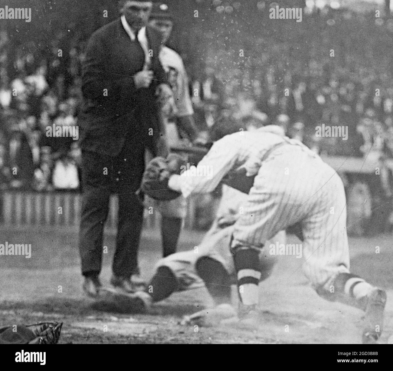 Umpire ready to make the call as catcher tags base runner sliding into ...