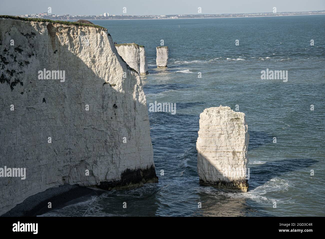 Beautiful shot of rocky chalk cliffs in the sea at the Purbeck Heritage ...