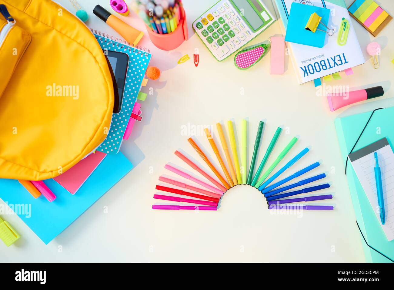 Back to school. Upper view of white table with workbooks, stationary ...