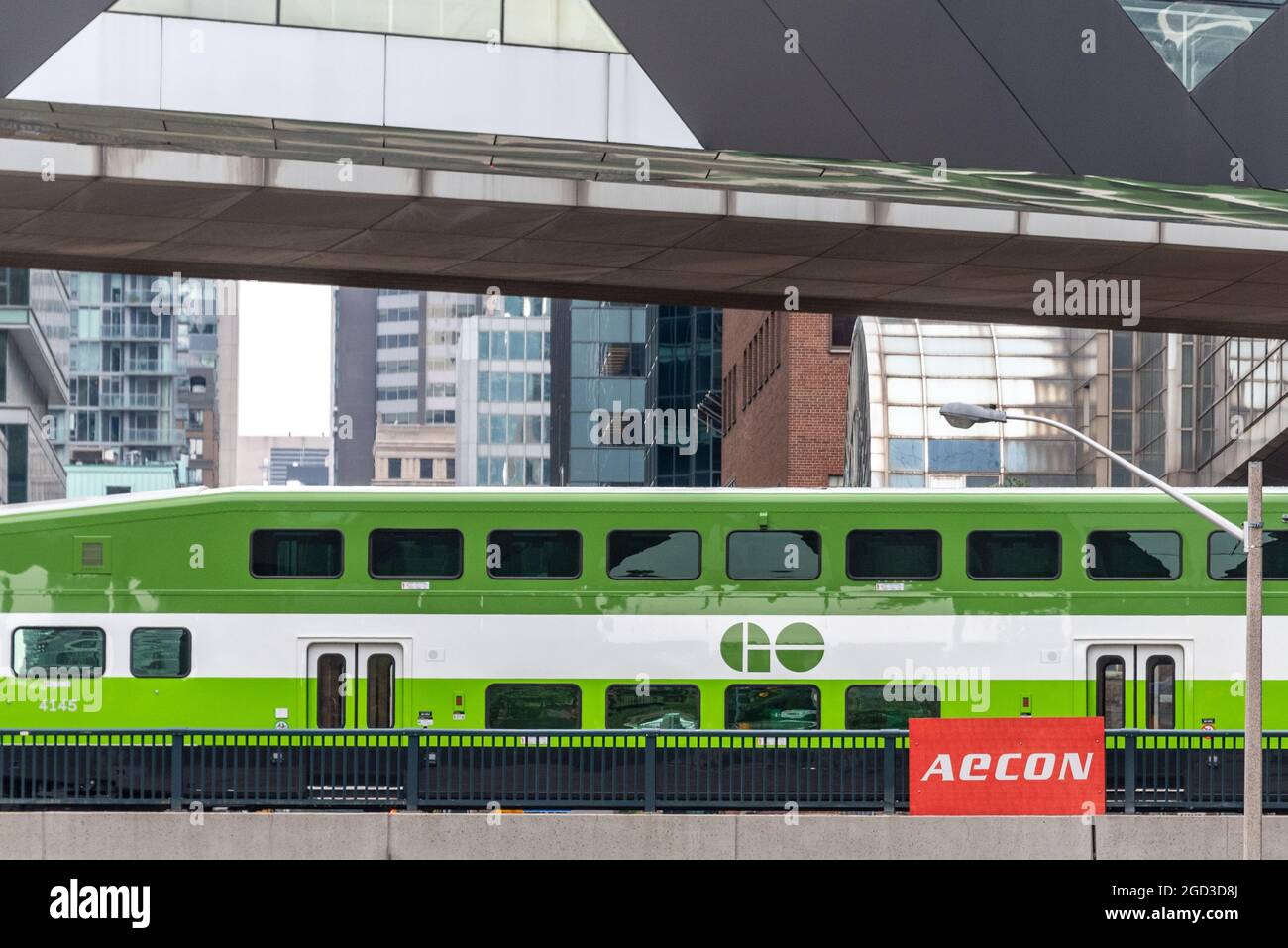GO train of the Metrolinx Corporation passing below the skywalk ...