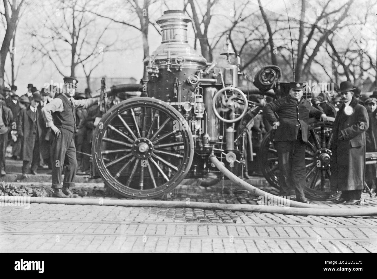 Two firemen with fire engine ca. 1909 Stock Photo - Alamy