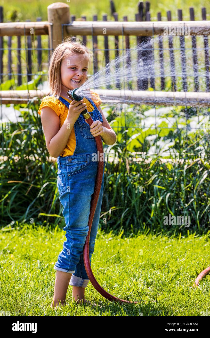 Child with hose hi-res stock photography and images - Alamy