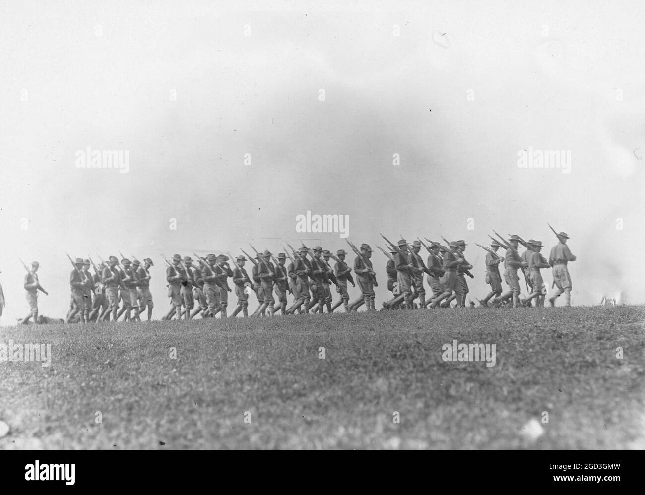 Soldiers marching with rifles in a field, probably a U.S. Army training ...