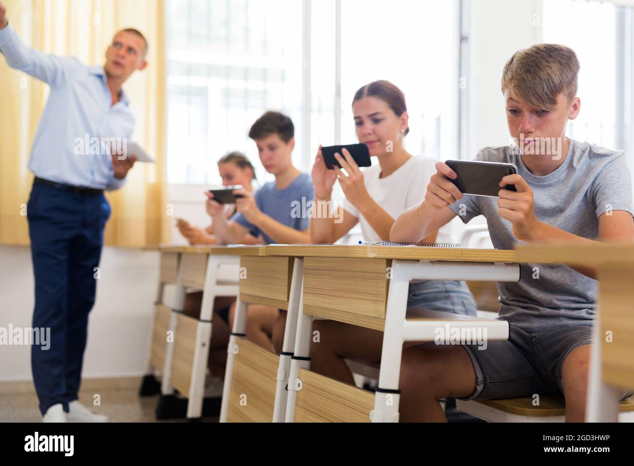 Classmates using their smartphones heavily during classes closeup Stock ...