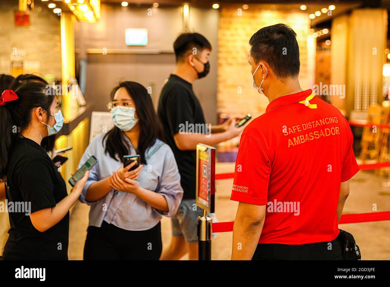 A safe distancing ambassador seen at a food court at Marina Bay Sands ...
