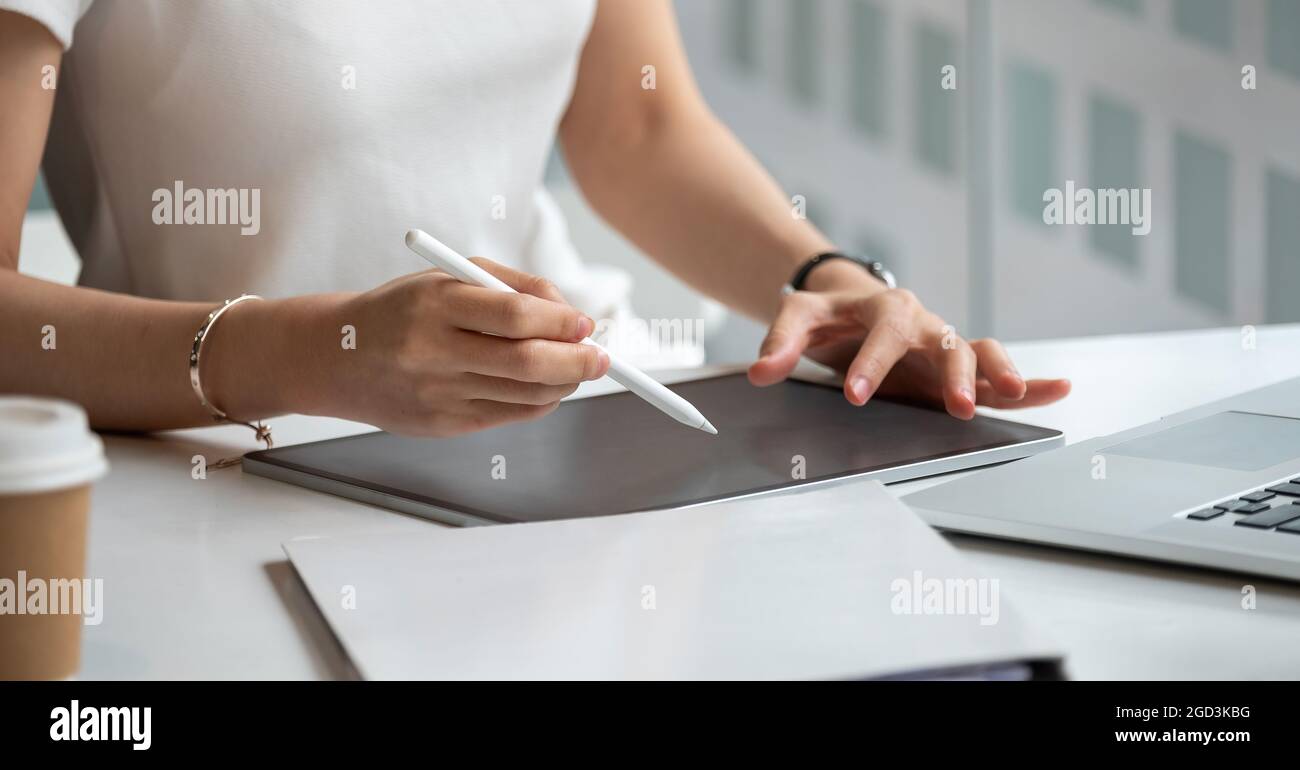 Young business woman hands holding pen stylus and working on black ...