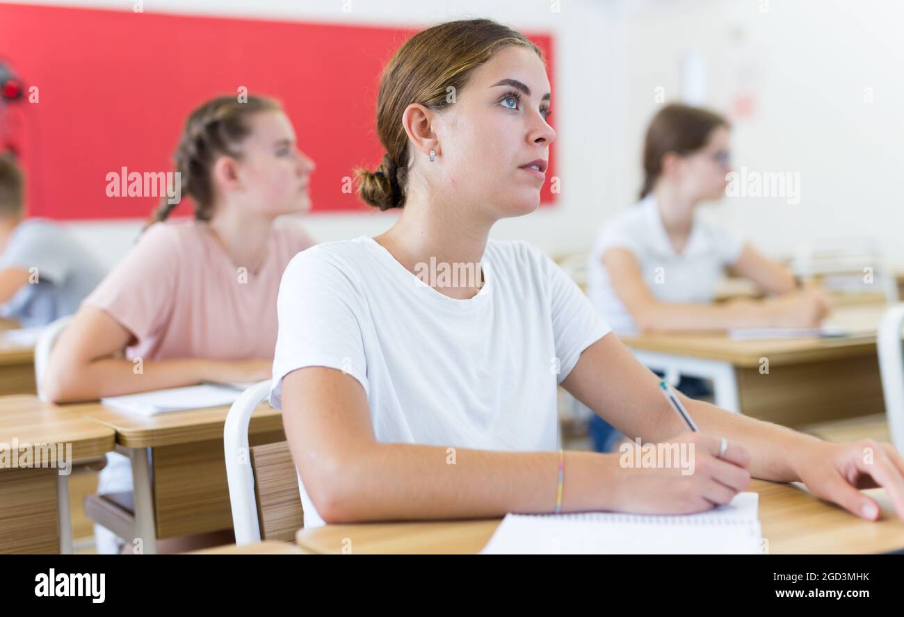 Teenager students sitting at desks Stock Photo - Alamy