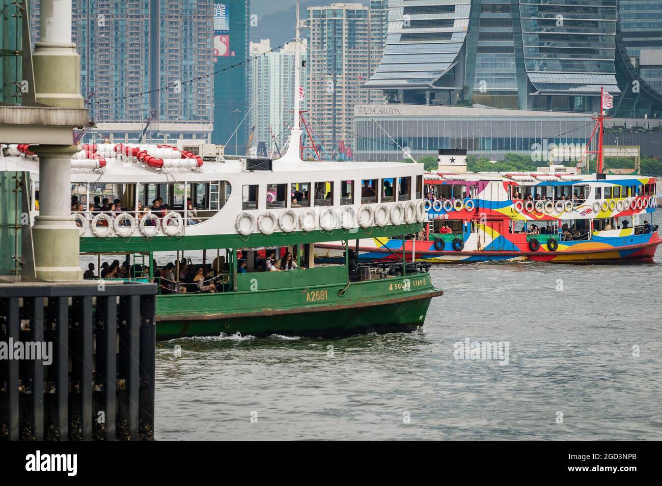 The 'Solar Star', one of the Star Ferry fleet, passes the 'Night Star' while crossing Victoria ...