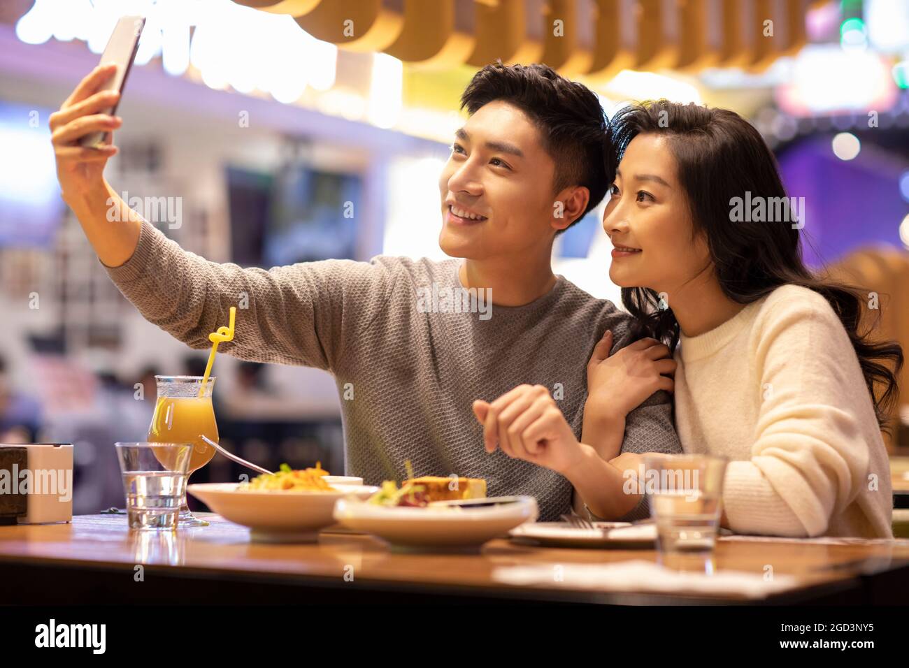 Happy young couple dating in restaurant Stock Photo - Alamy