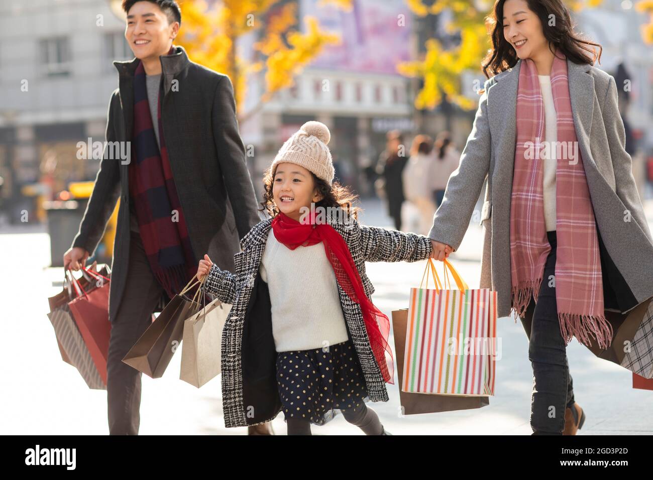 Happy young family shopping together Stock Photo - Alamy